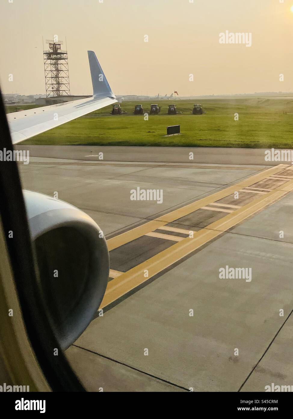 Sunrise on the runway, runway markings, towers and flags, engine ...