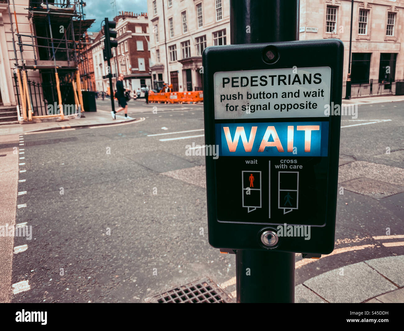 A button and display at a pedestrian crossing telling pedestrians to ...