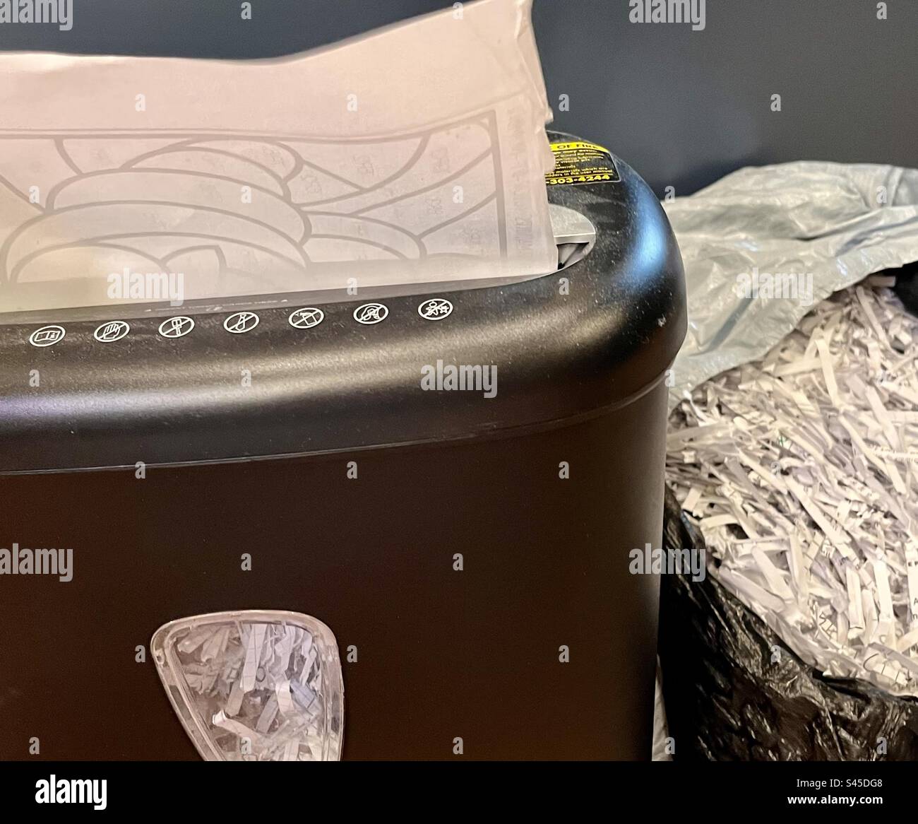 Shredded next to a trash bag full of shredded paper Stock Photo - Alamy