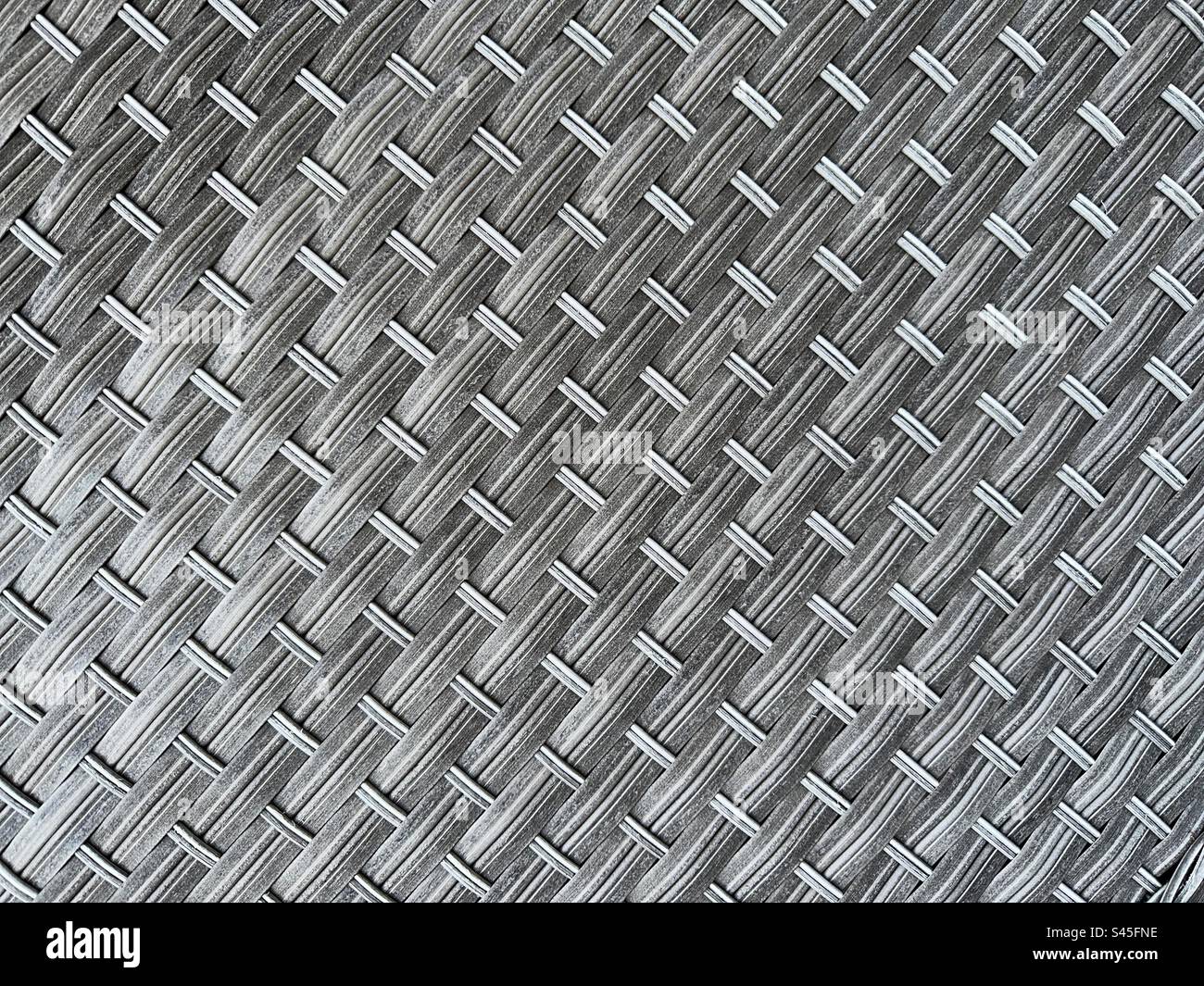 Pattern formed by the weave of a piece of rattan garden furniture ...