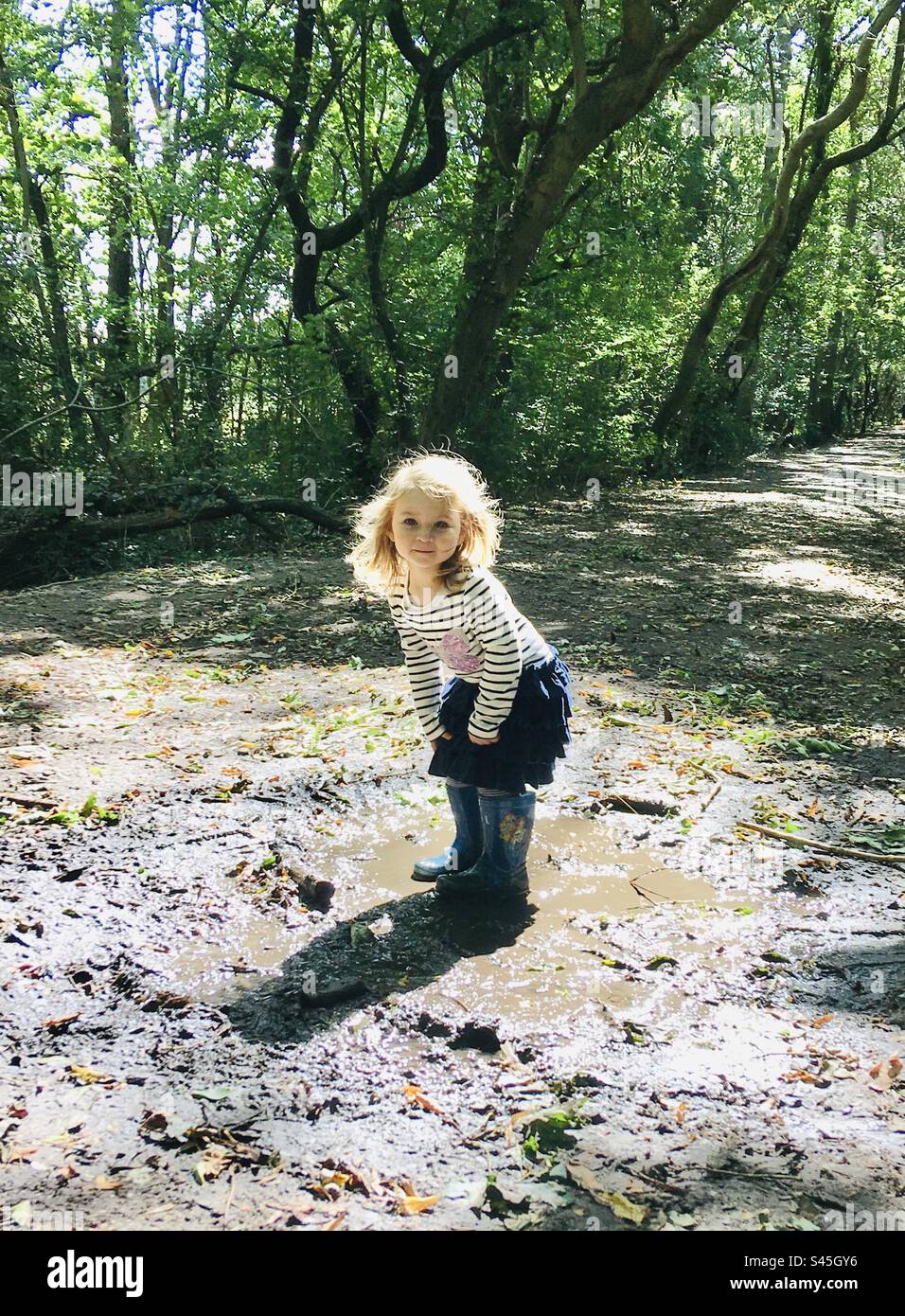Girl jumping in muddy puddle hi-res stock photography and images - Alamy