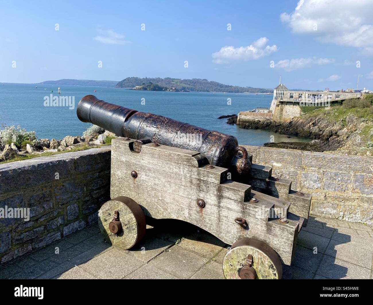 An ancient cannon pointing out to sea at Plymouth in Devon Stock Photo ...