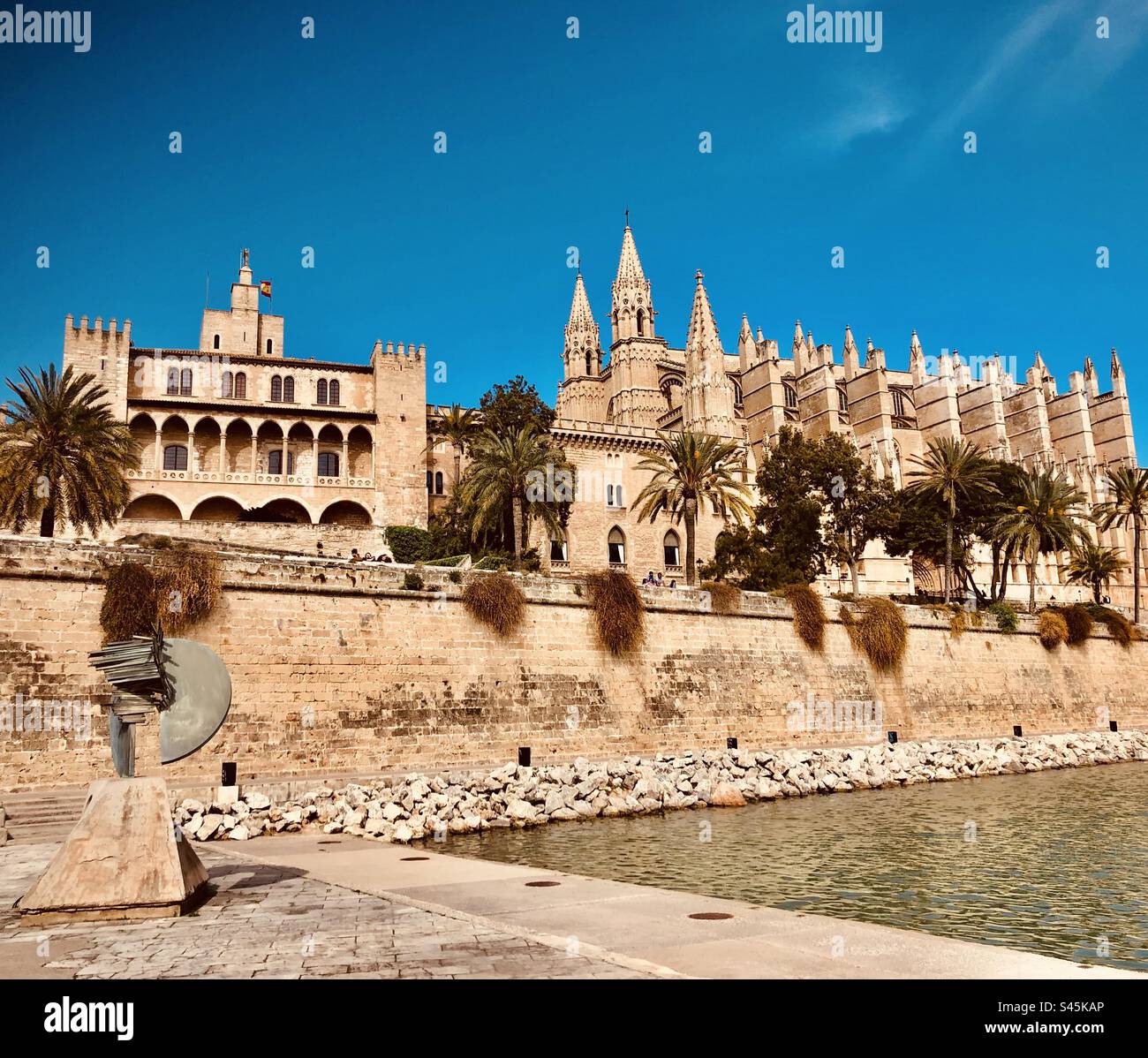 Palma de Mallorca skyline with catedral and palacio against blue sky ...