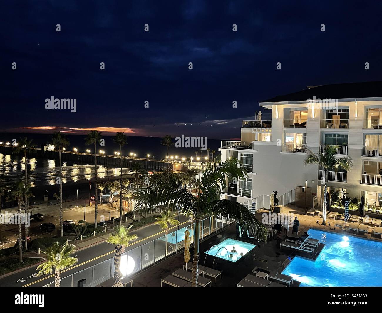 Beachfront hotel at night Stock Photo - Alamy