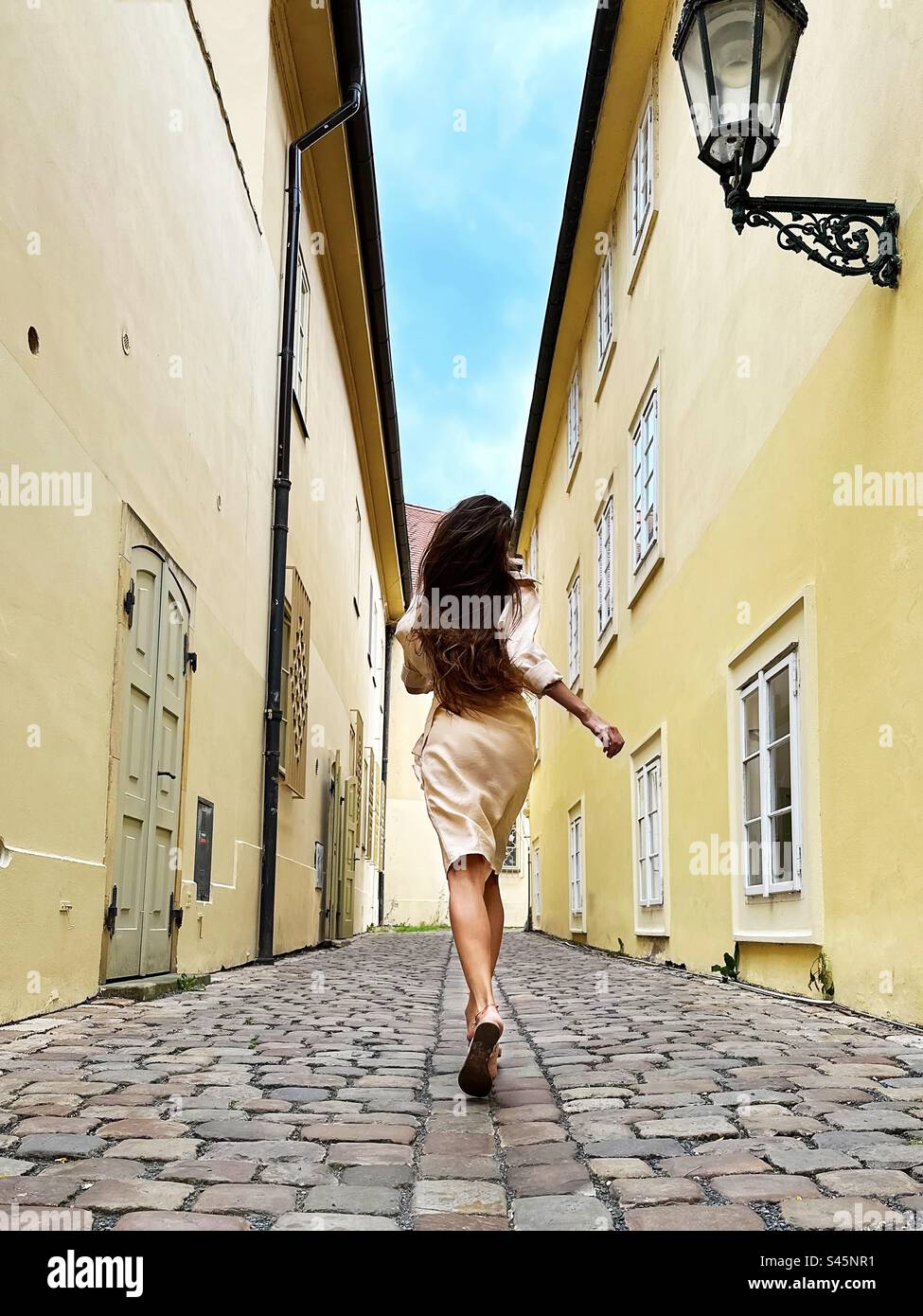 Running down the street Stock Photo - Alamy