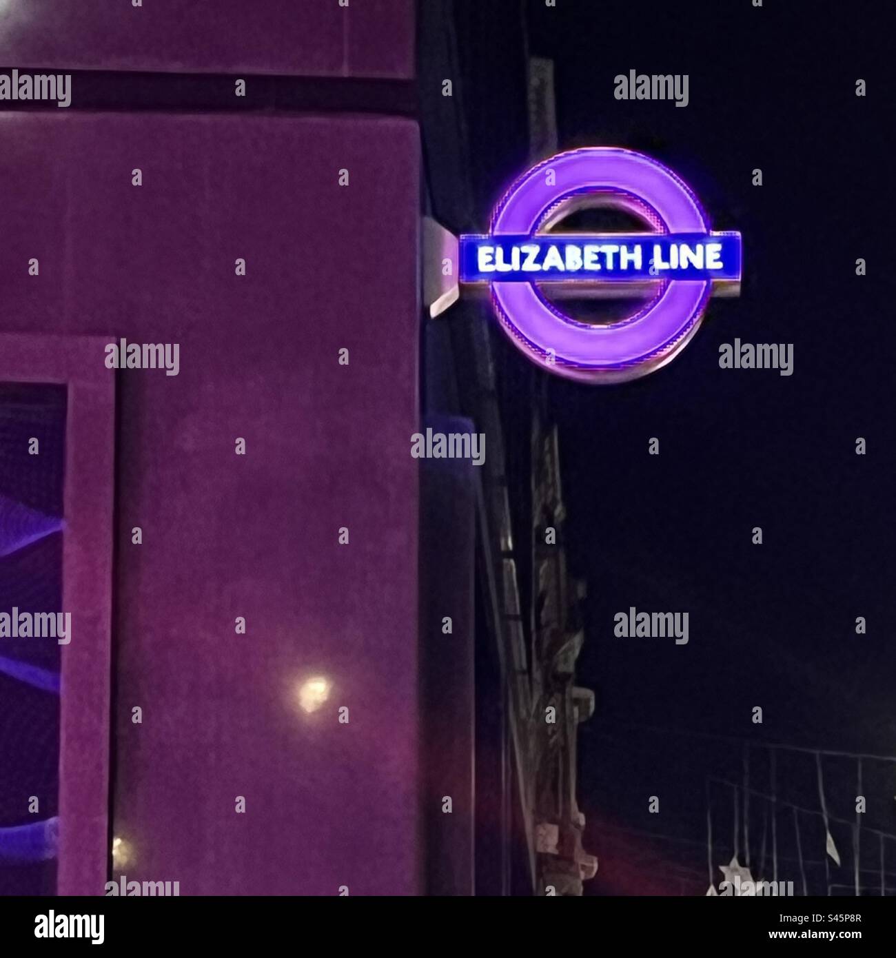 London Elizabeth Line Roundel at night Stock Photo - Alamy