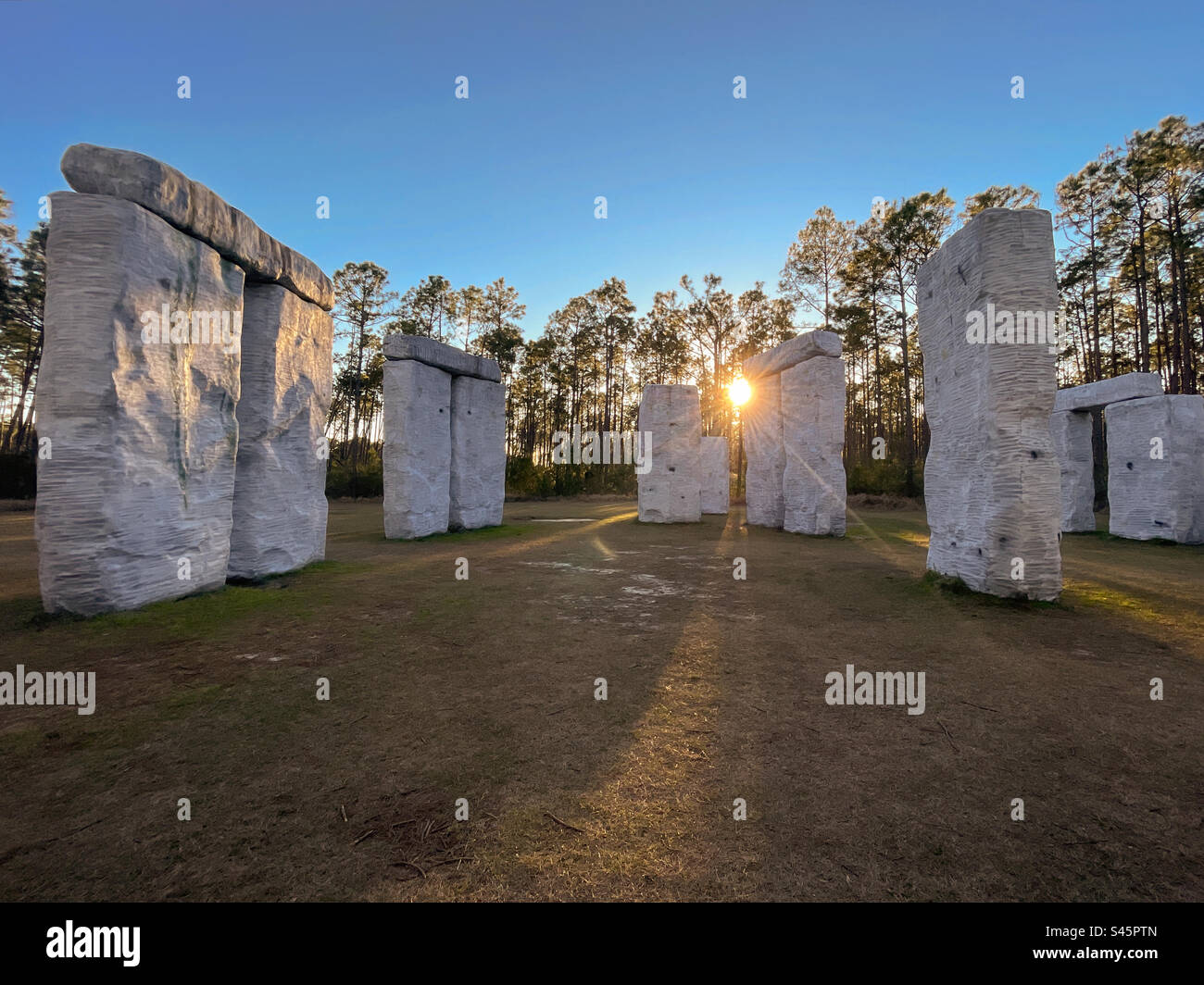 Sun star through Bamahenge, Elberta, Alabama Stock Photo - Alamy