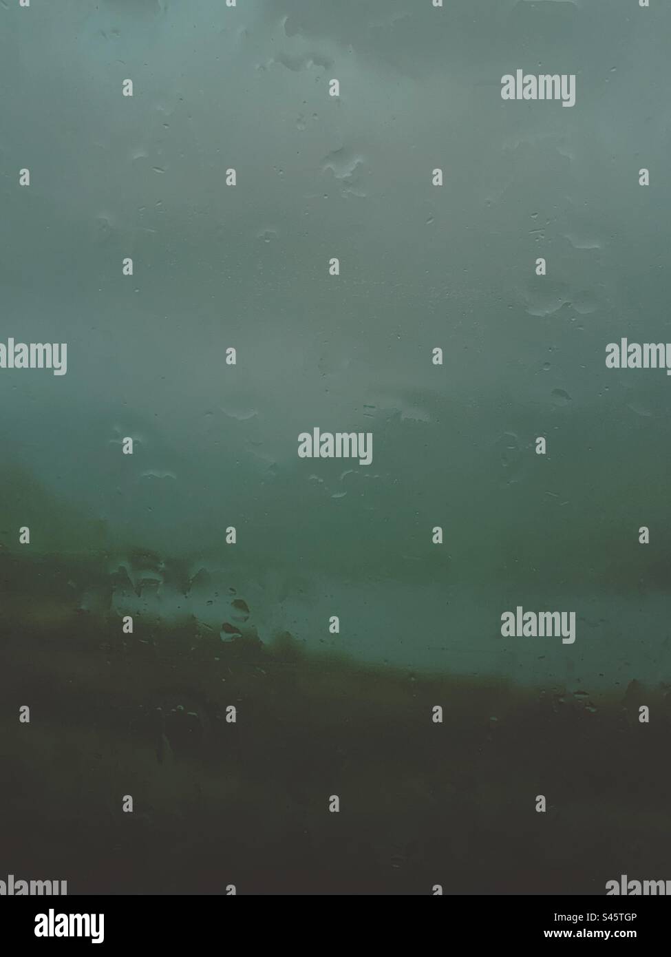 A wet rain weather mountain and lake minimal landscape- raindrops ...