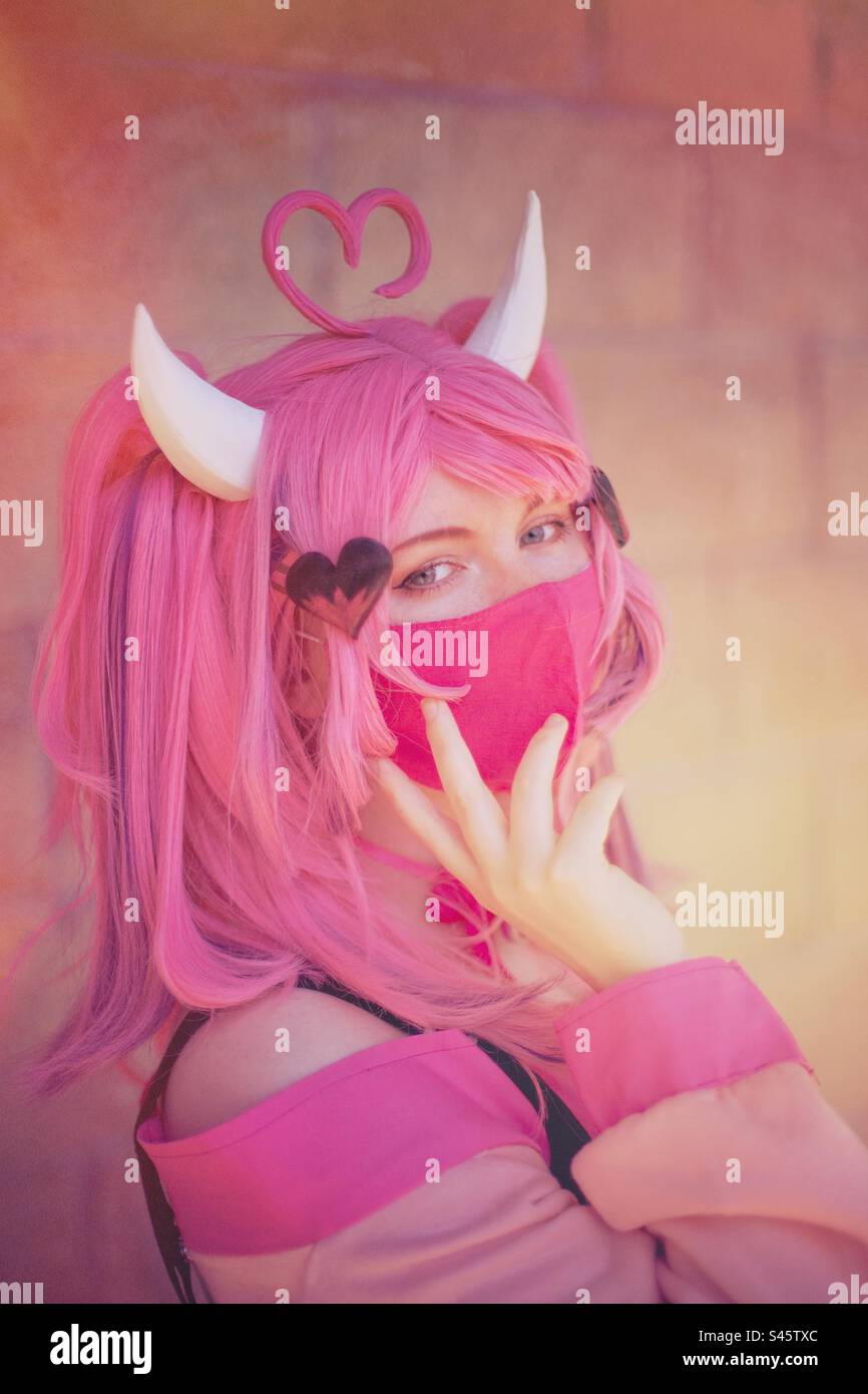 A pretty girl in pink anime cosplay costume head and shoulders portrait ...