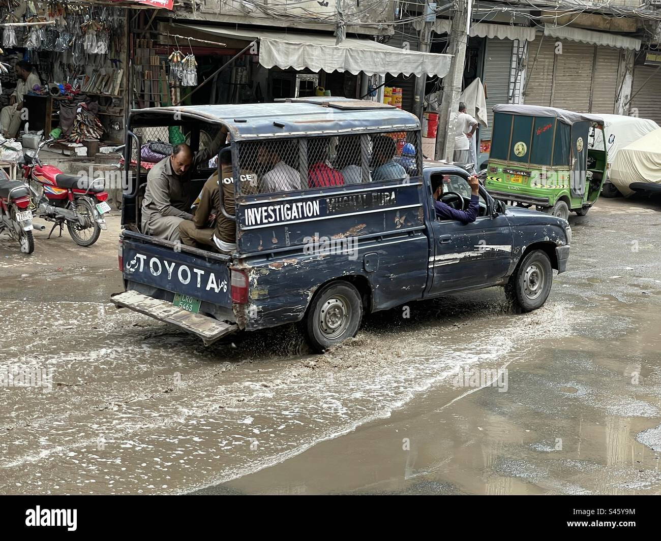 Police van moving through rain water with arrested prisoners Stock ...