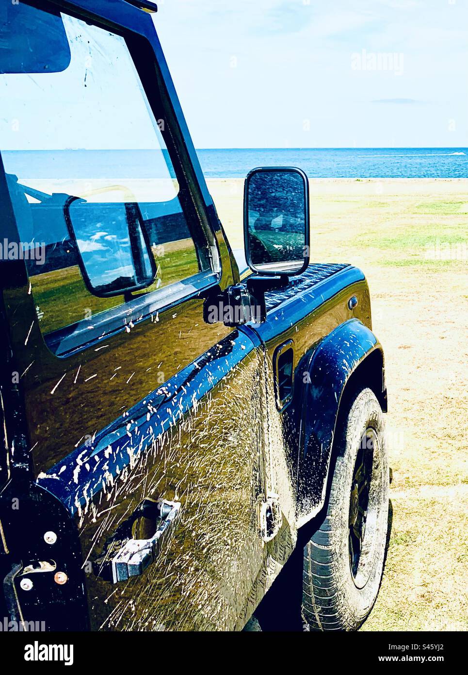 Dirty Land Rover Defender at the beach Stock Photo - Alamy
