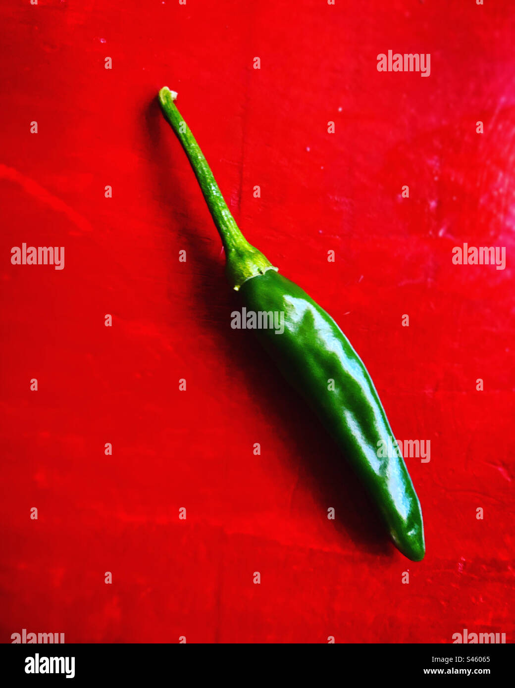 A green hot chilli pepper in a red table in Queretaro, Mexico Stock ...