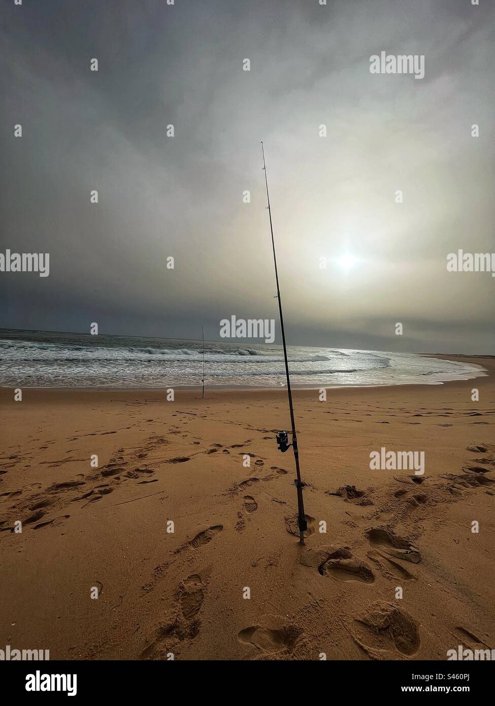 Fishing rod on the beach as the sunsets Stock Photo - Alamy