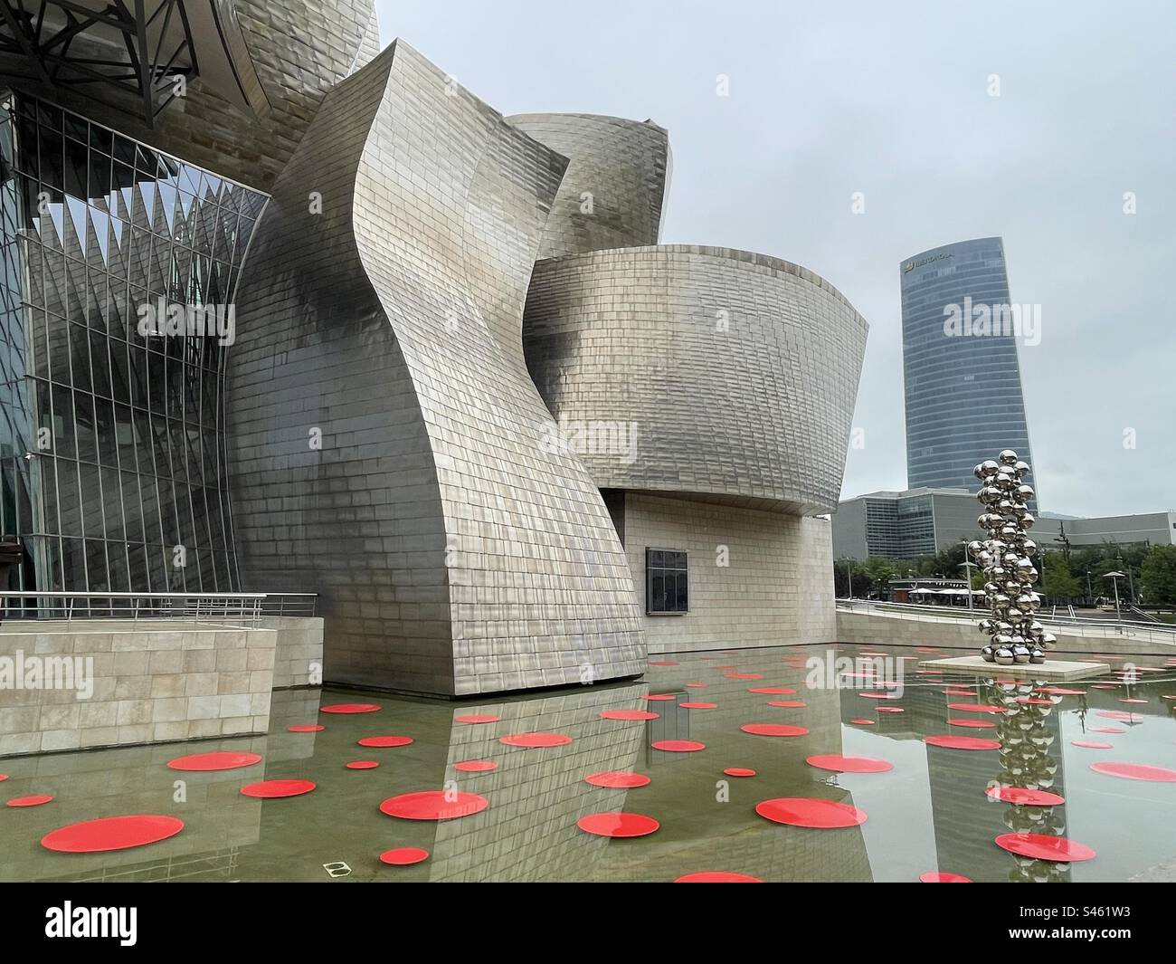 Chromatic contrast, red spots on reflecting pool. Guggenheim Museum in ...