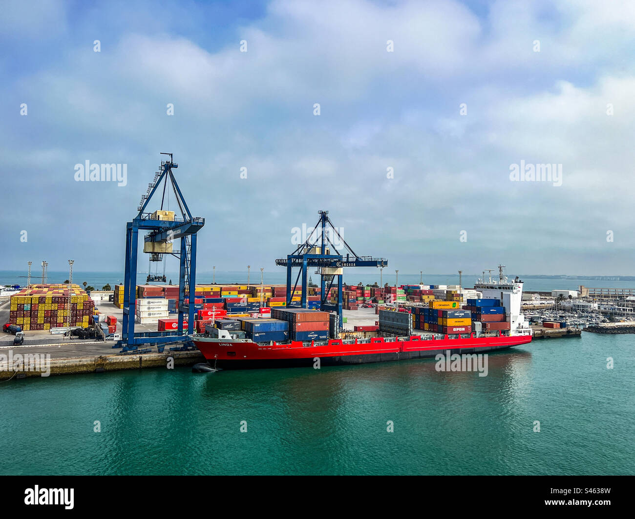 Container ship being loaded of containers in the port of Cádiz in Spain ...