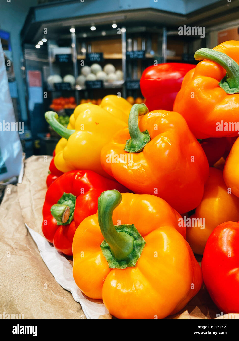 Yellow and red bell peppers for sale at a produce stall in the food ...