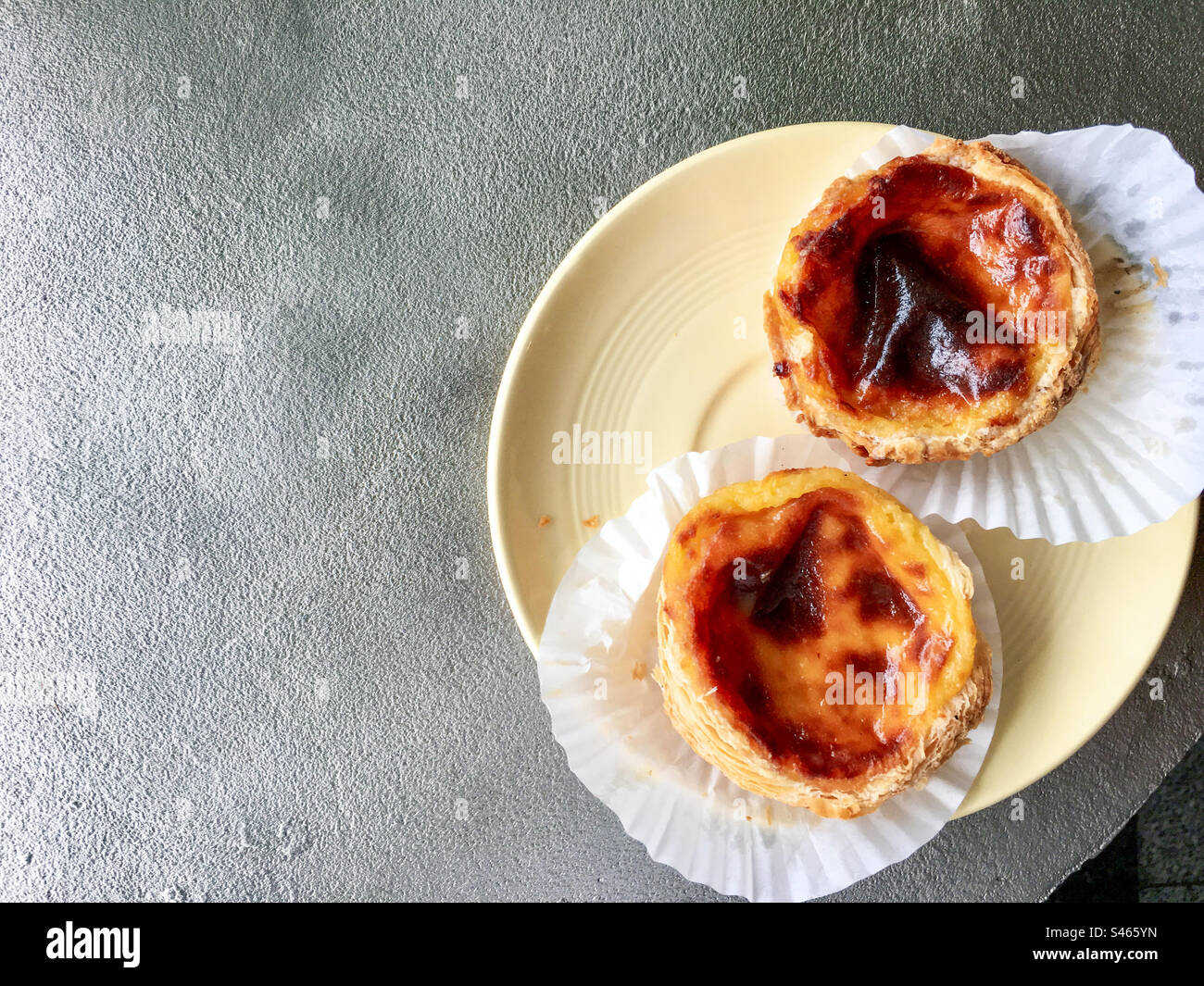 Two Pastel de Nata egg Portuguese egg custard tarts with negative space ...