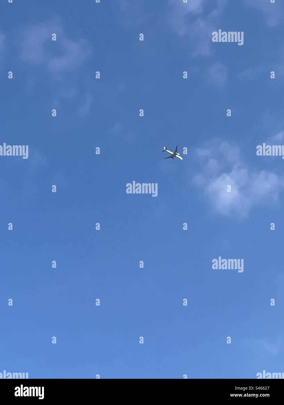 Plane up in the skies. View from the ground. Travel the world Stock ...