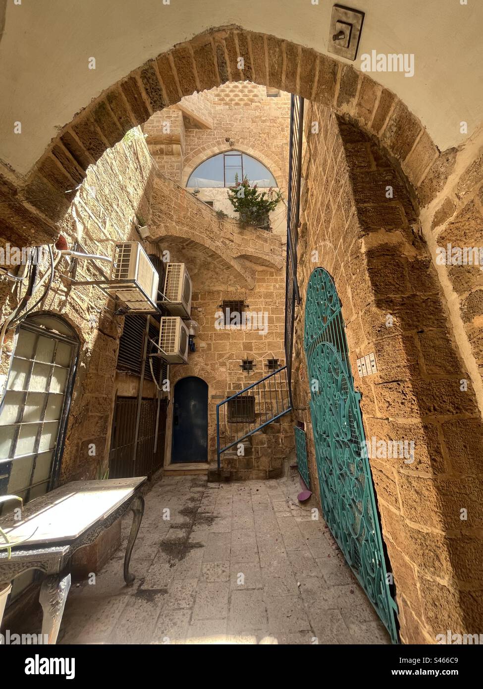 Pretty corridor of an ancient city in Israel. Bricks and brown walls ...
