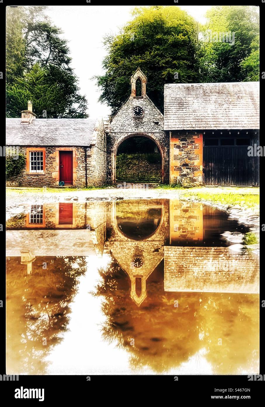 Farm building reflected in a puddle Stock Photo - Alamy