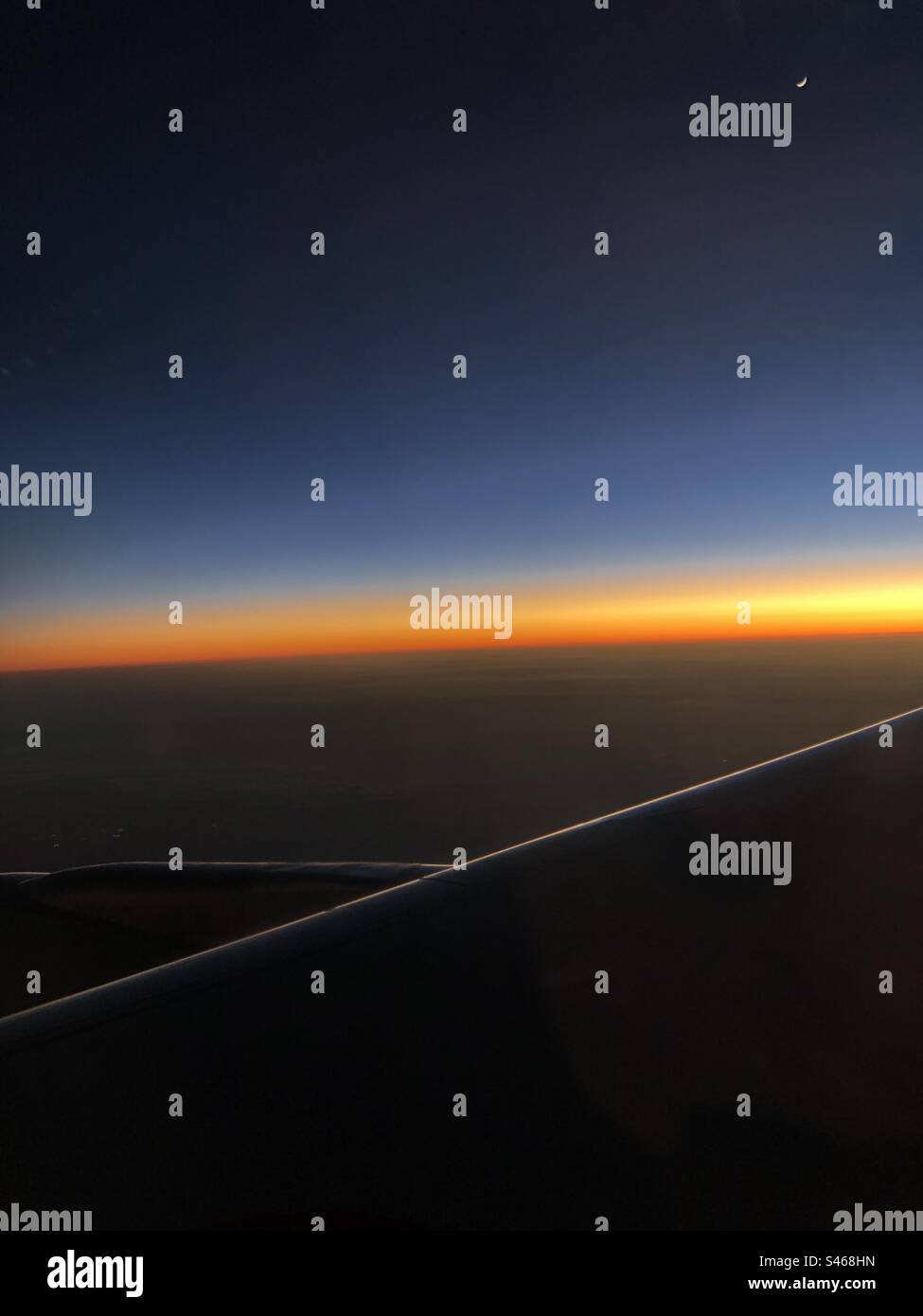 Airplane wing at night with sunset Stock Photo - Alamy