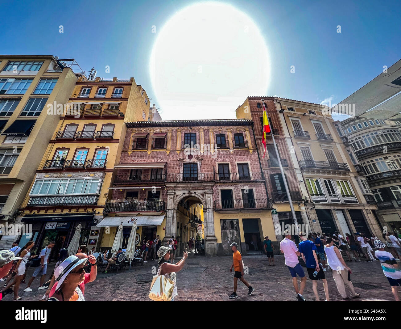 Large sun behind buildings in Malaga Spain Stock Photo - Alamy