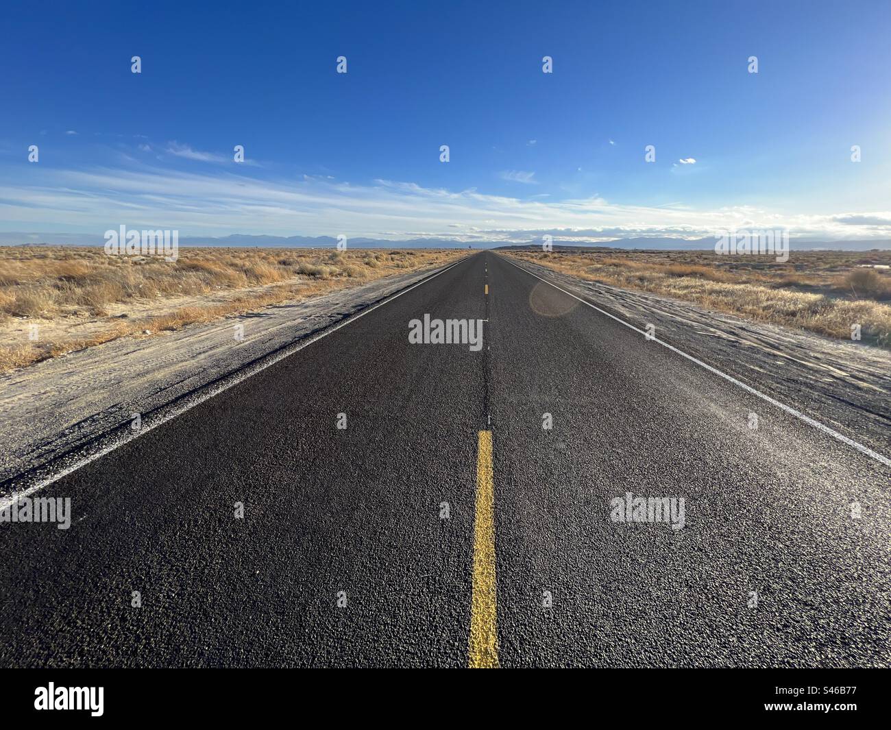 Fresh black asphalt with bright yellow markings on highway through the ...