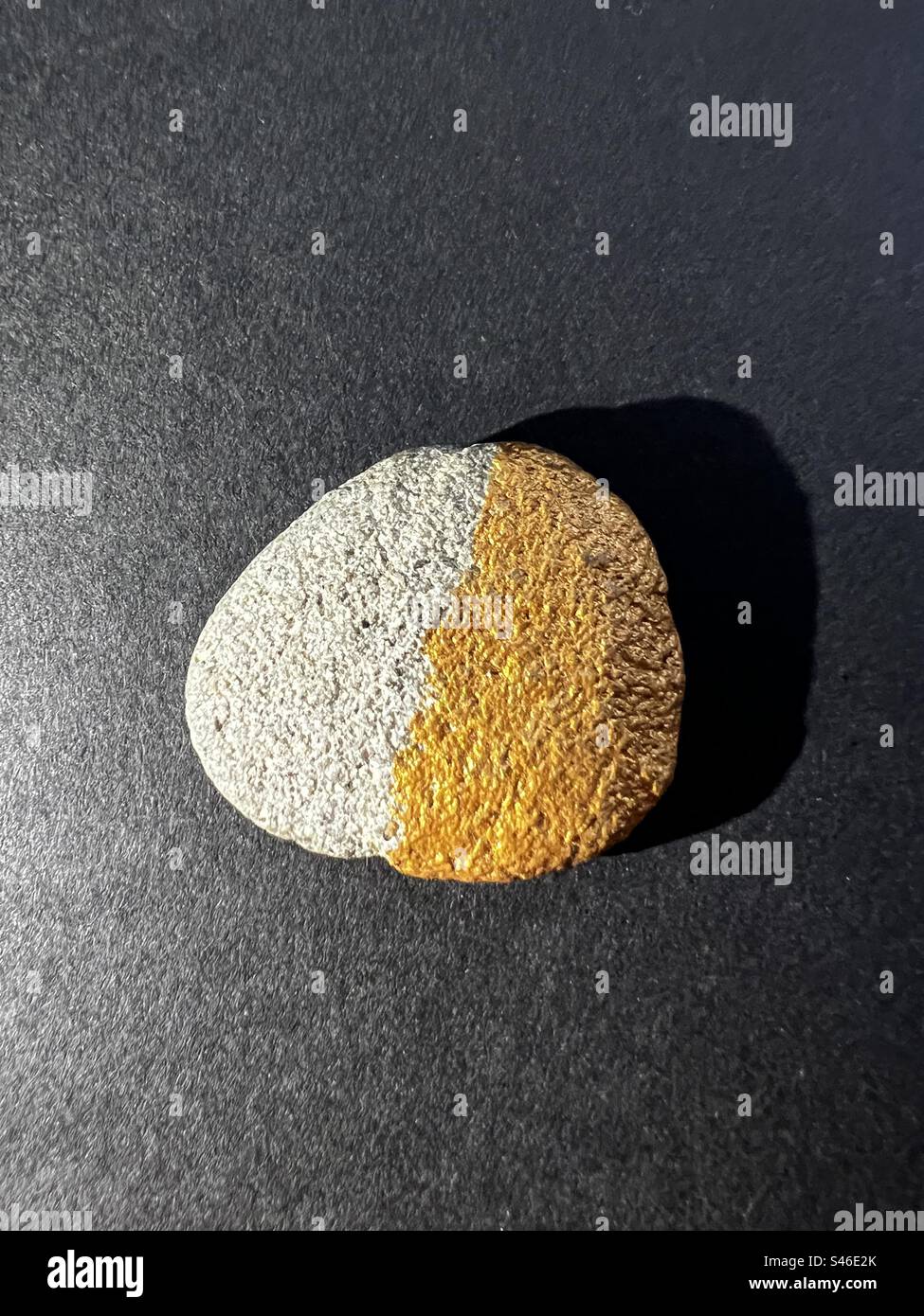 Gold painted rock Stock Photo - Alamy