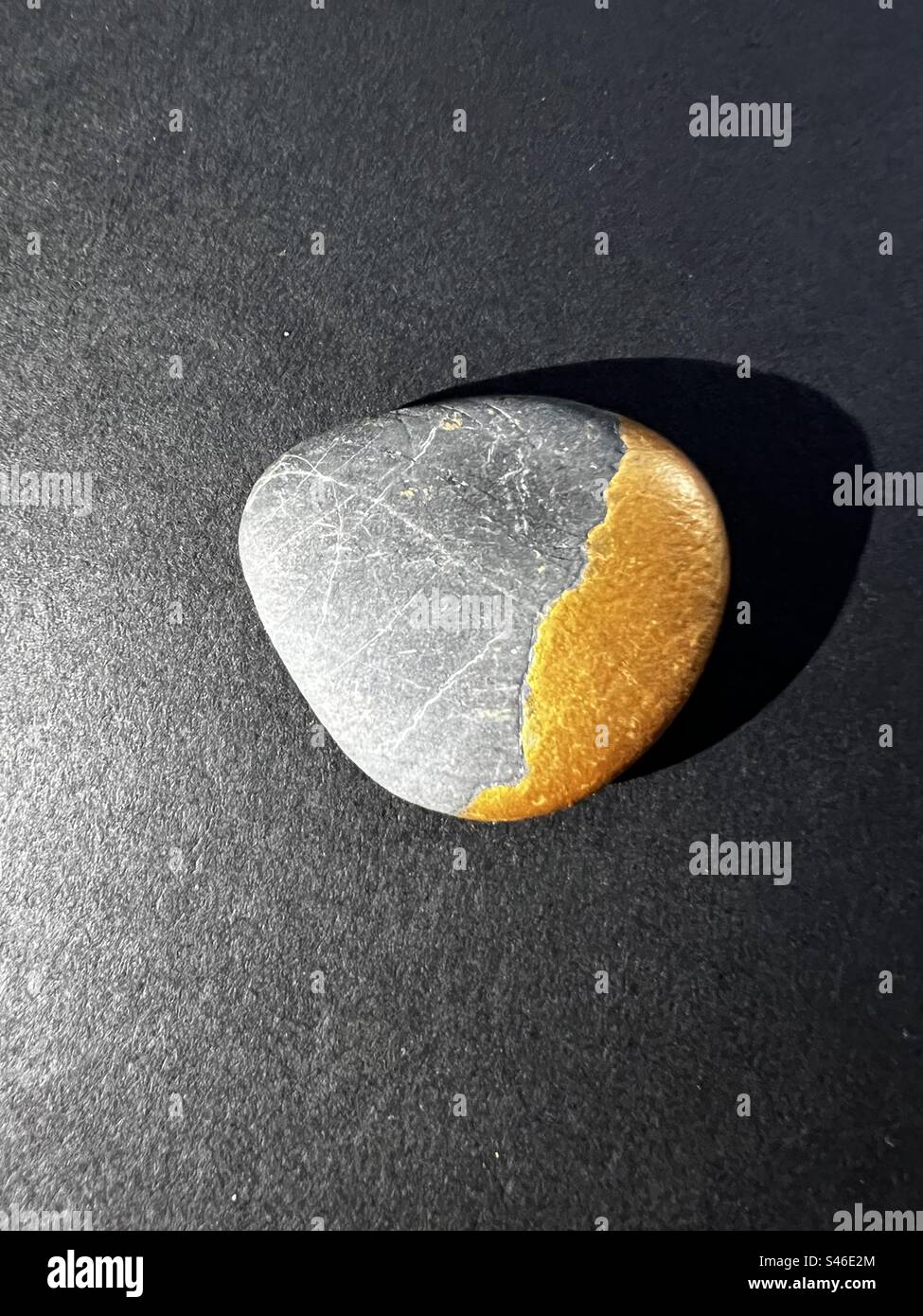 Gold painted rock Stock Photo - Alamy