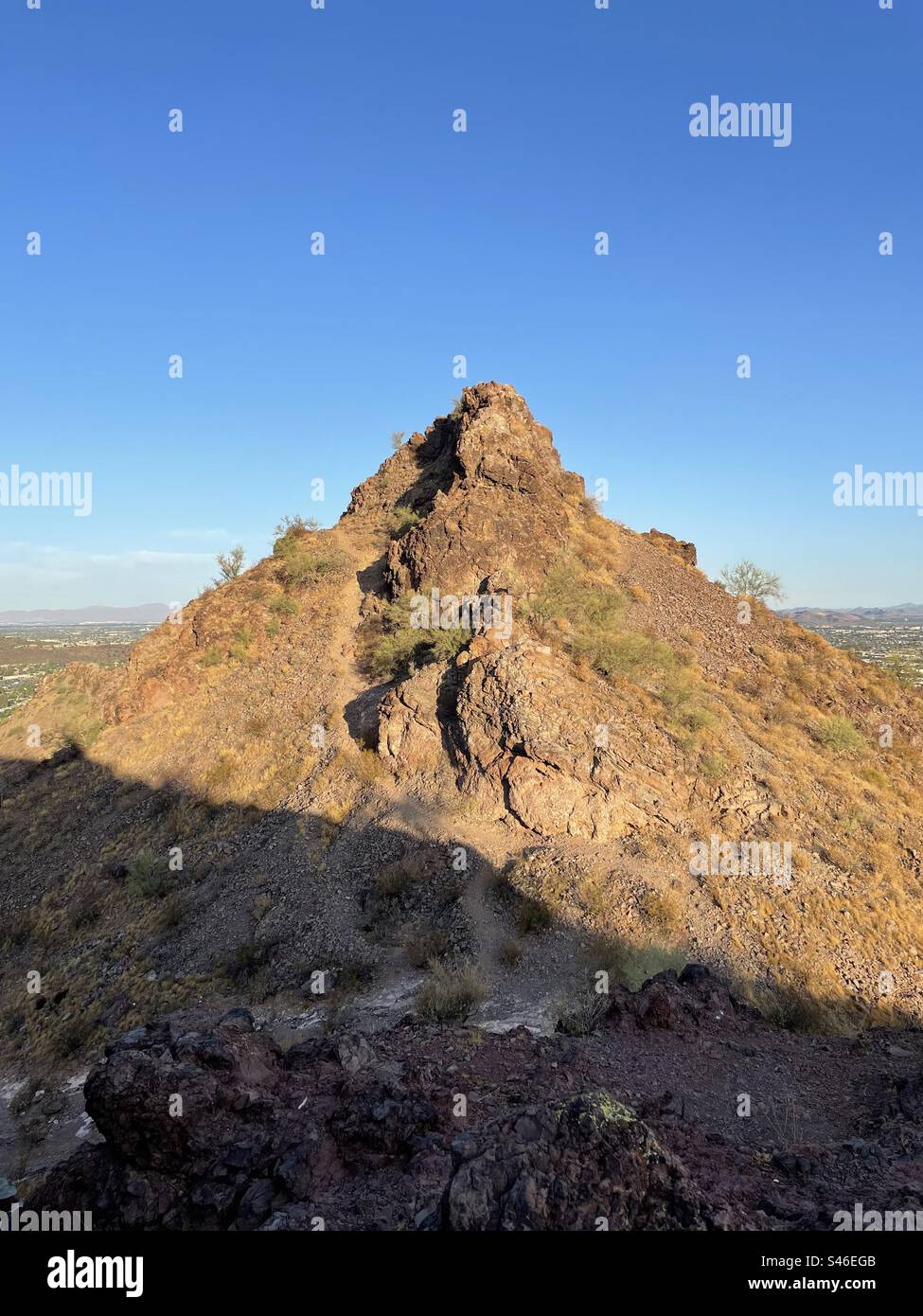 Pyramidal secondary peak, rocky trail to its summit, framed by ...