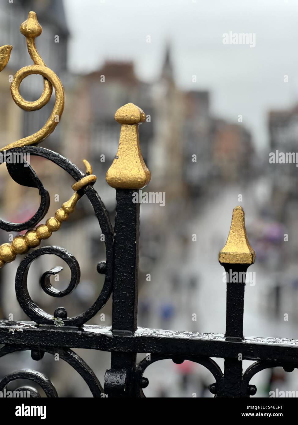 Historical Chester through gold painted fence Stock Photo - Alamy