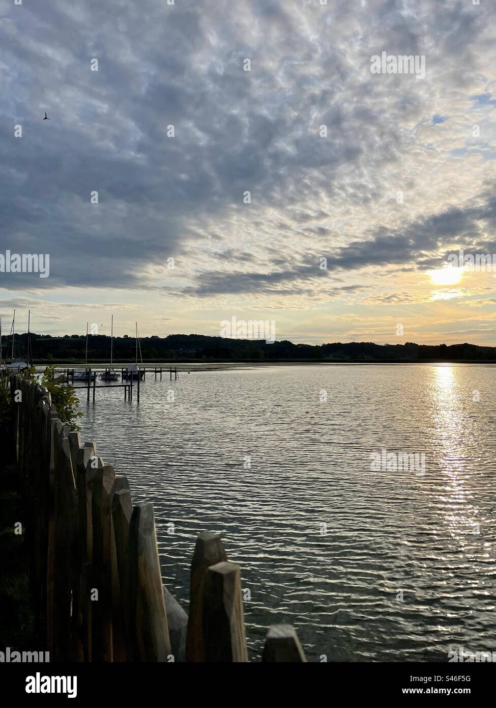 Sunset at Chiemsee Park Bernau-Felden beach, located by the famous Chiemsee lake in Germany ...