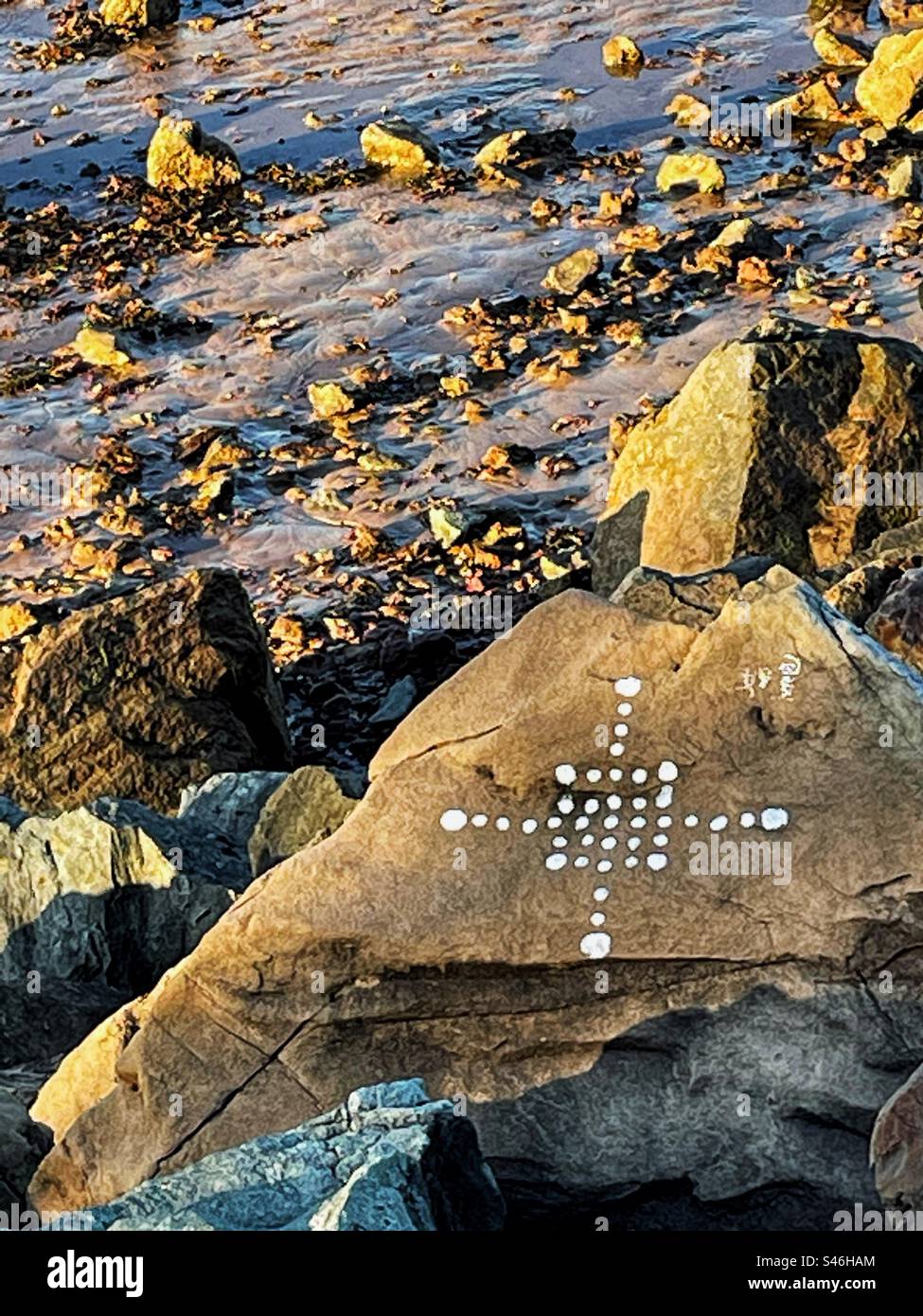 Pattern painted on a sunny rock wall boulder Stock Photo - Alamy