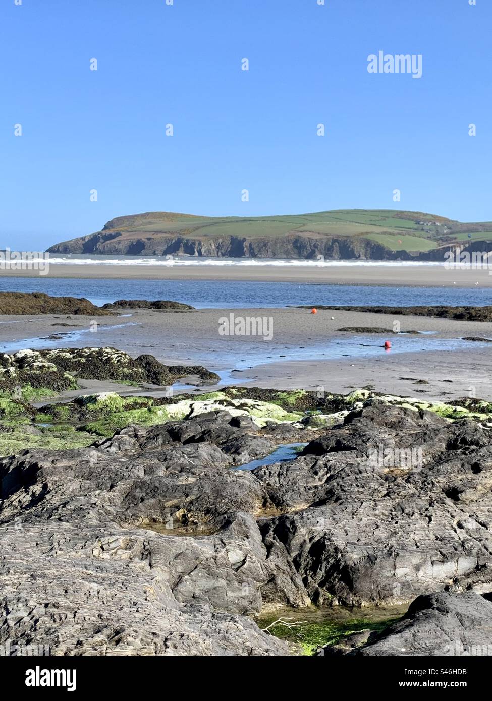View across rock pools onto Newport Sands beach, Pembrokeshire, wales ...