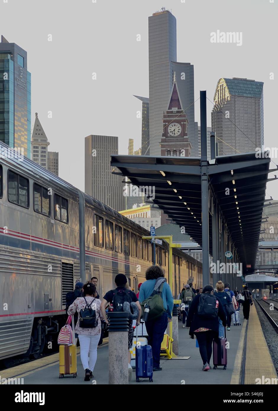 Train passengers arriving at Seattle’s King Street Railway Station on a late summer evening with ...