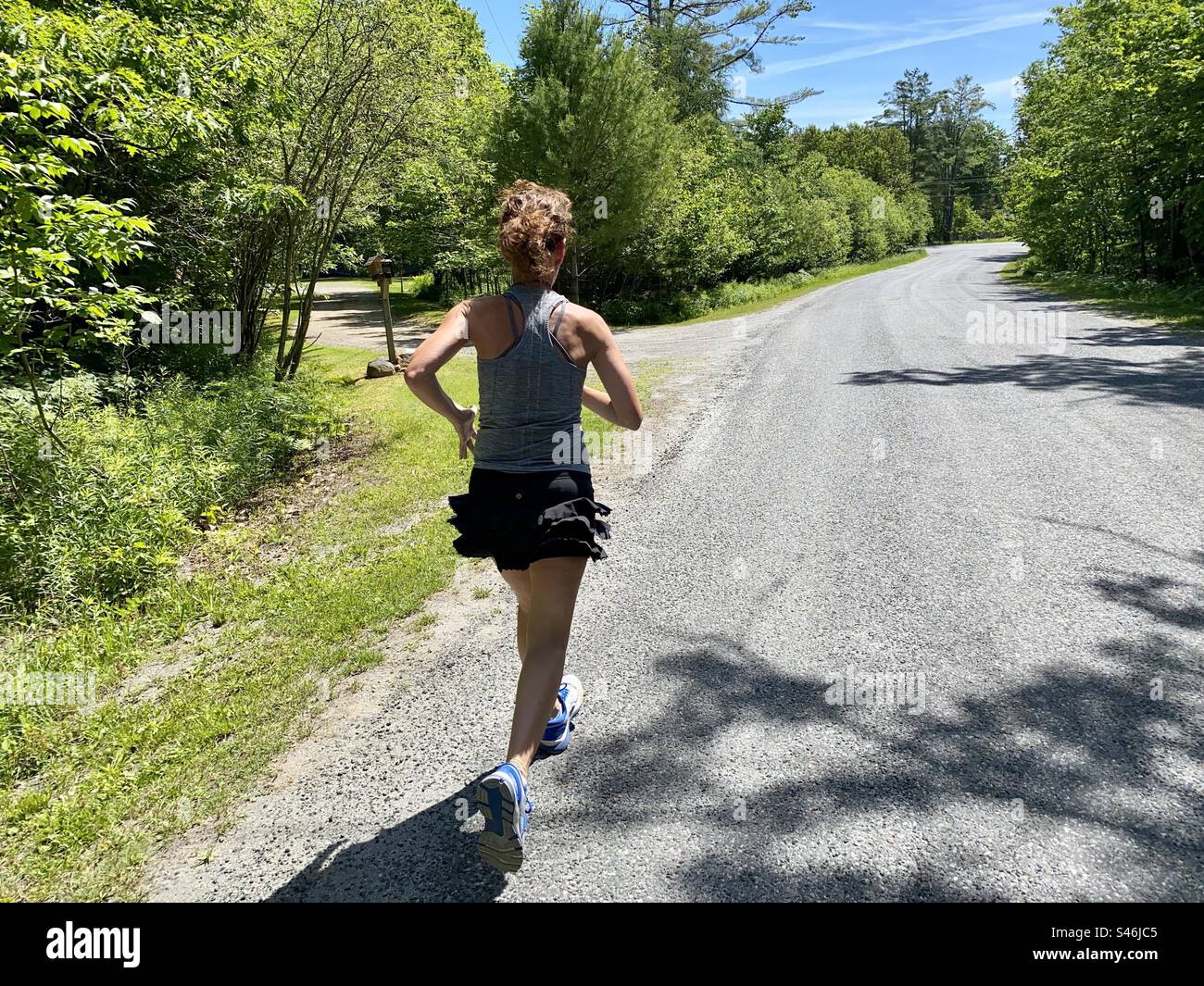 Girl running on country road hi-res stock photography and images - Alamy