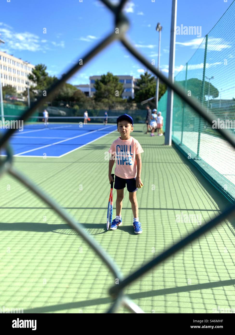 Sporty six year posing before tennis class begins. Lisbon, Portugal ...