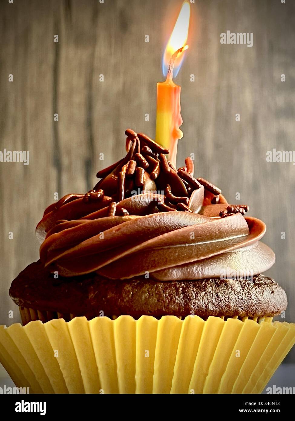 Chocolate cupcake with single birthday candle Stock Photo - Alamy