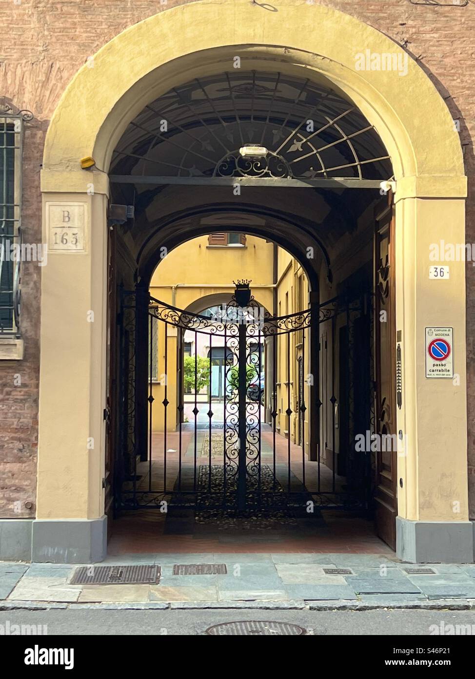 A gated arched entry on a street in Modena, Italy Stock Photo - Alamy
