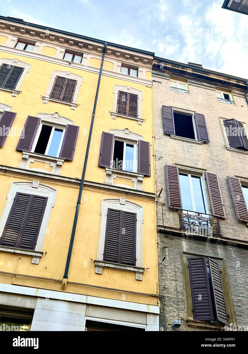 Yellow and tan buildings in old town Modena, Italy Stock Photo - Alamy