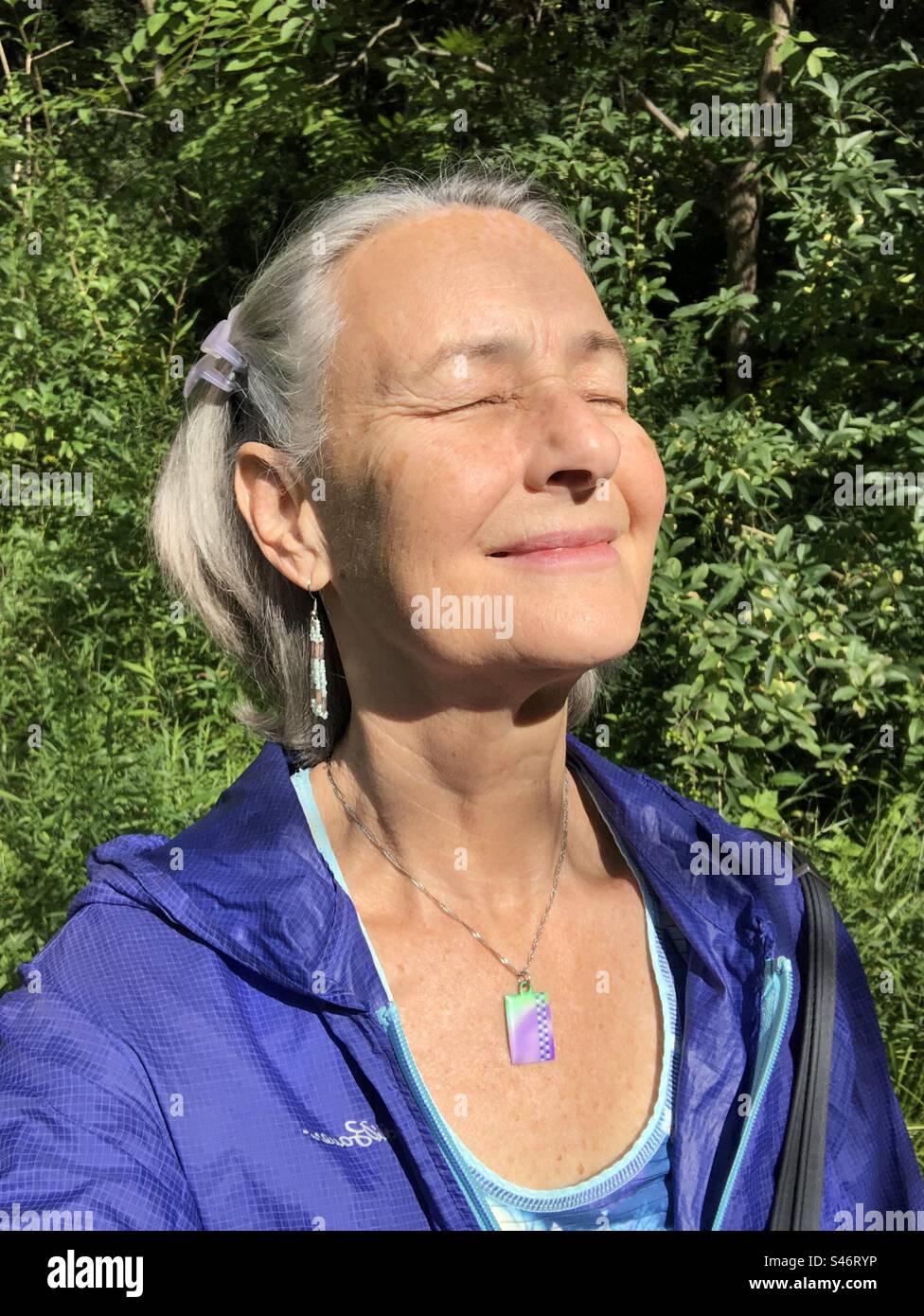 A woman enjoying the sunshine Stock Photo - Alamy