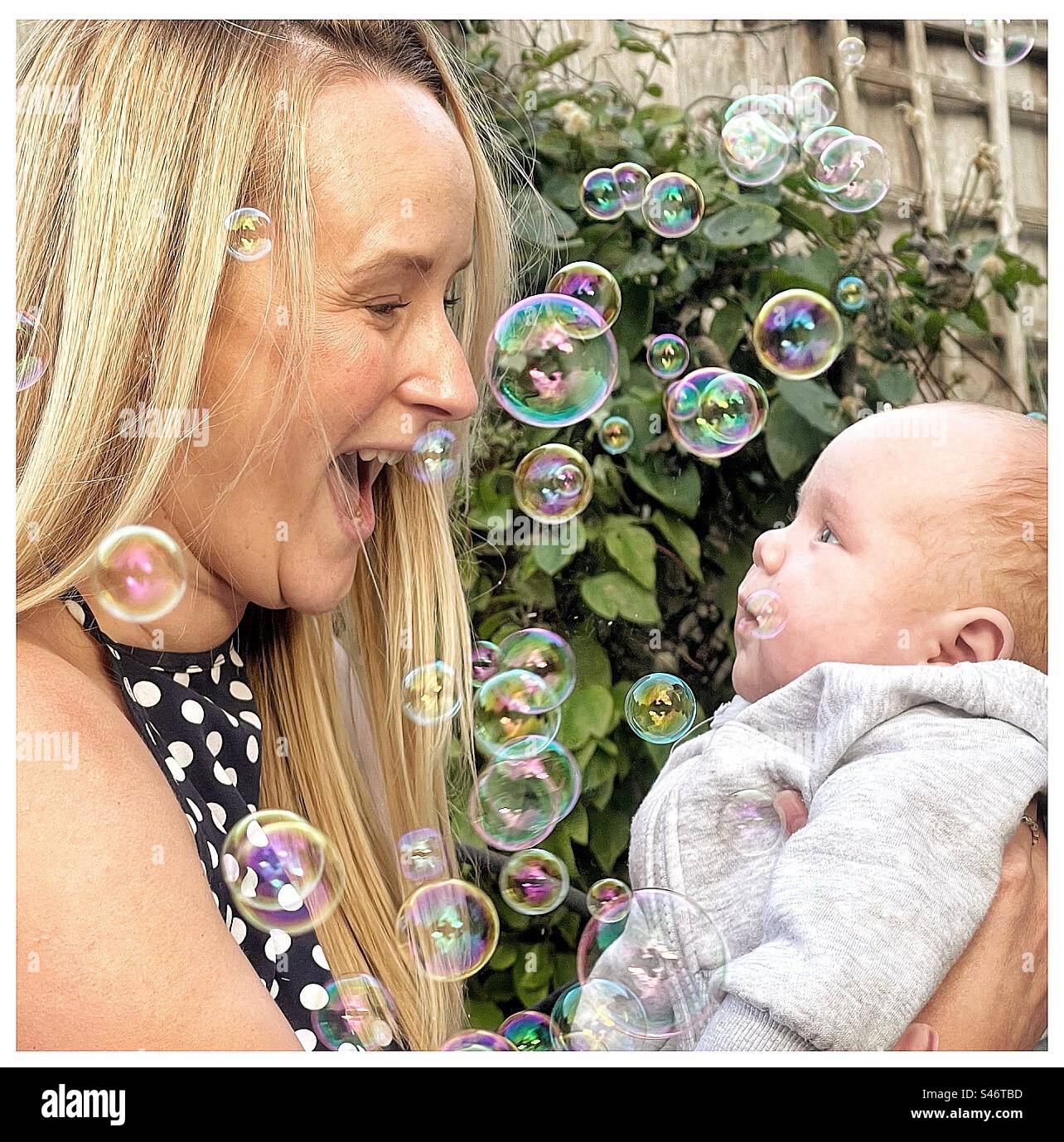 Young mum and her baby laughing at bubbles Stock Photo - Alamy