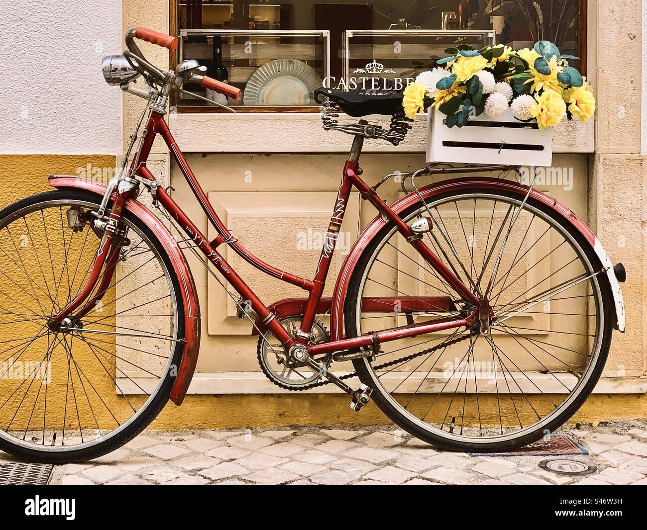 A red bicycle with a box of flowers on the back Stock Photo - Alamy