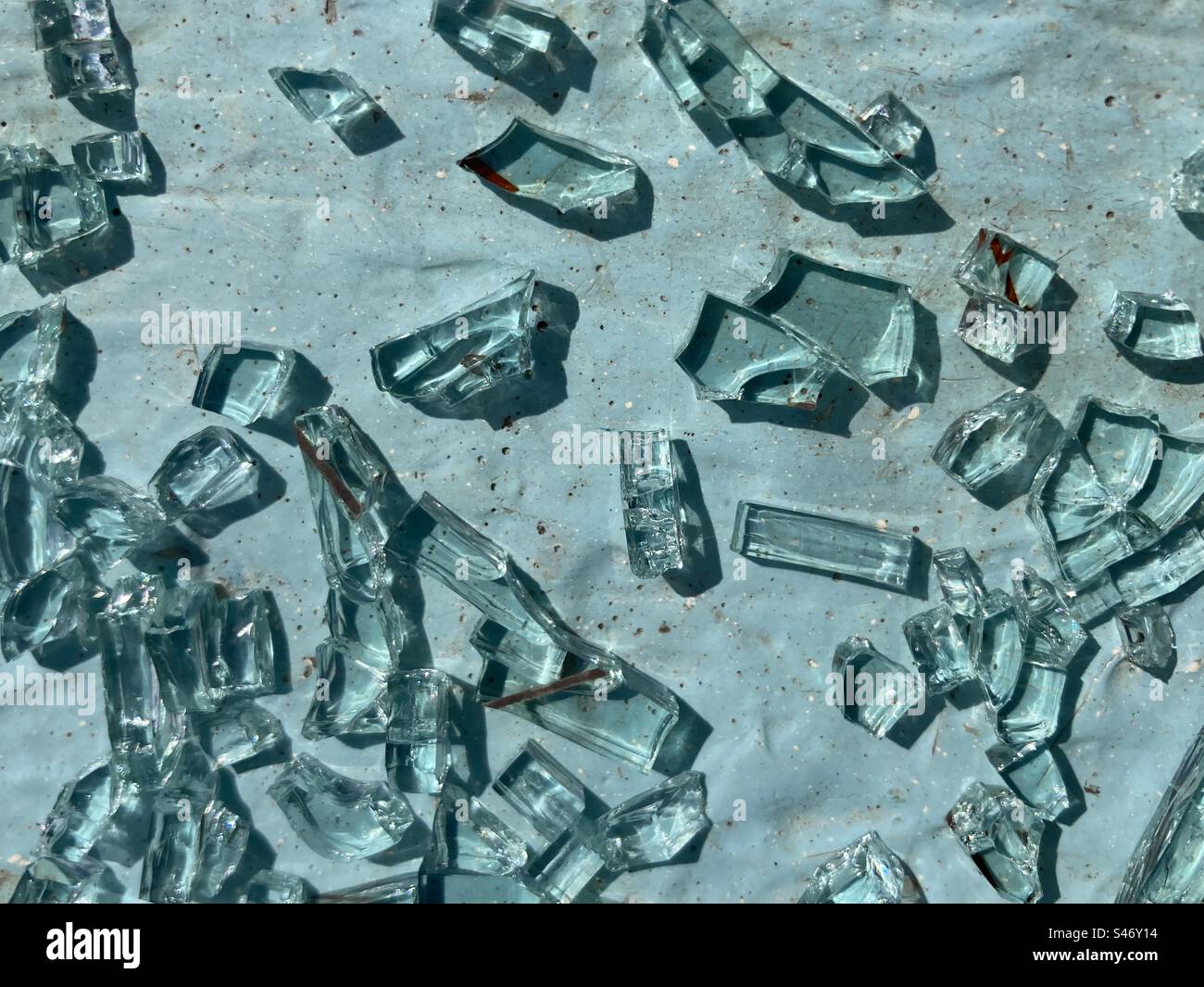 Glass fragments lie on blue background Stock Photo - Alamy