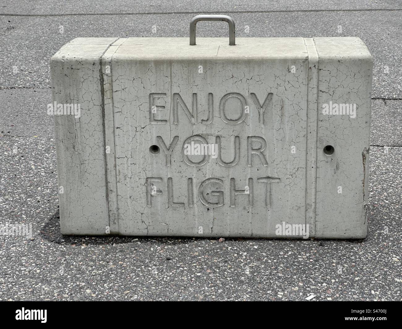 Enjoy your flight, carved message on a luggage of cement Stock Photo ...
