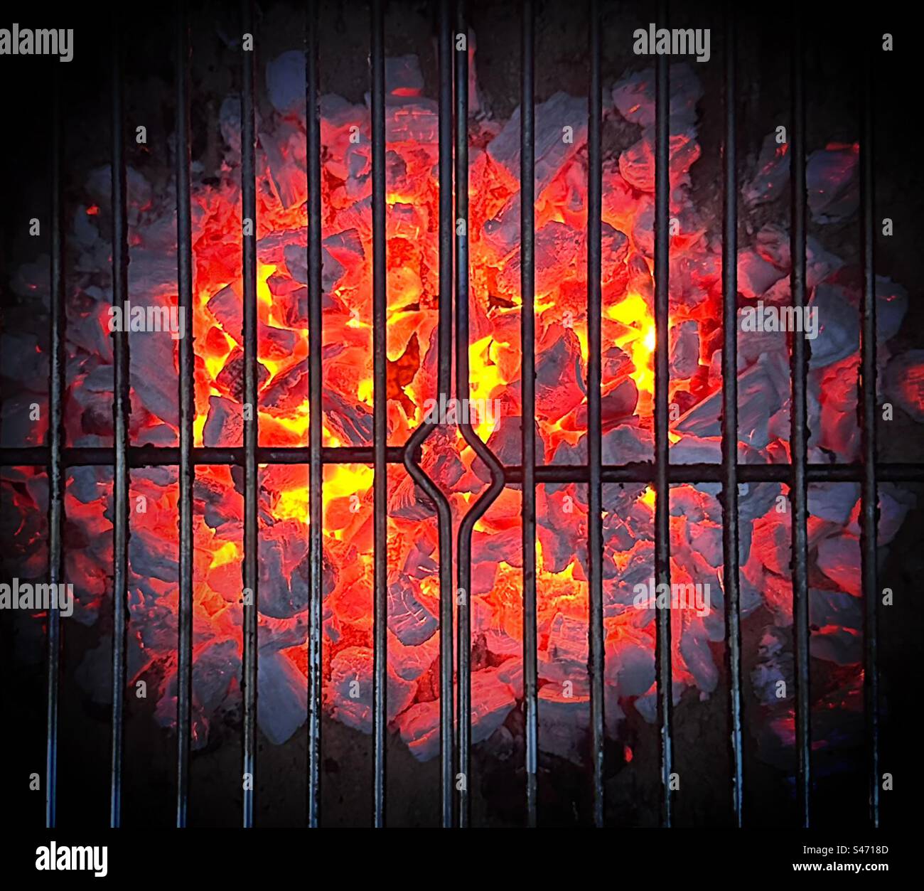 ‘BBQ Season’ close up of bright hot coals on a barbecue, ready to cook ...