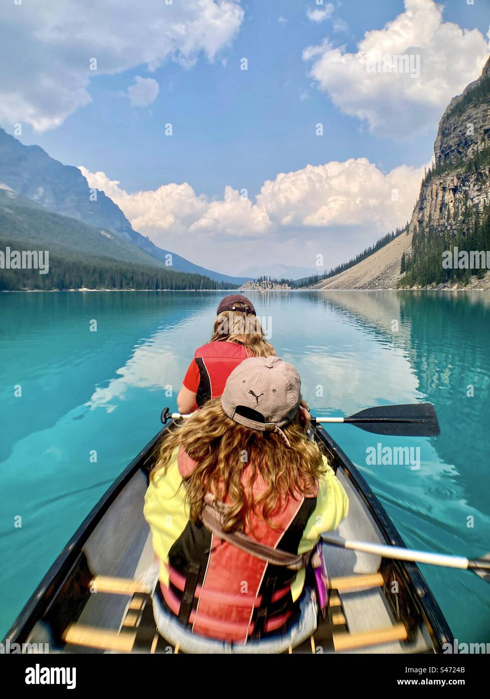 Paddling across the amazing glacial waters of Moraine Lake in Banff National Park, Alberta ...