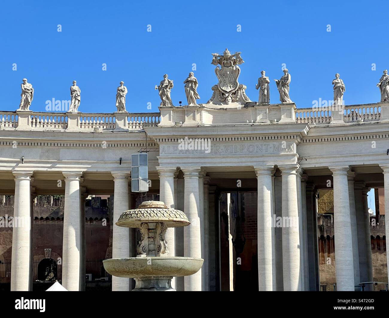 Bernini Fountain, columns, and statues of saints in Saint Peter’s ...