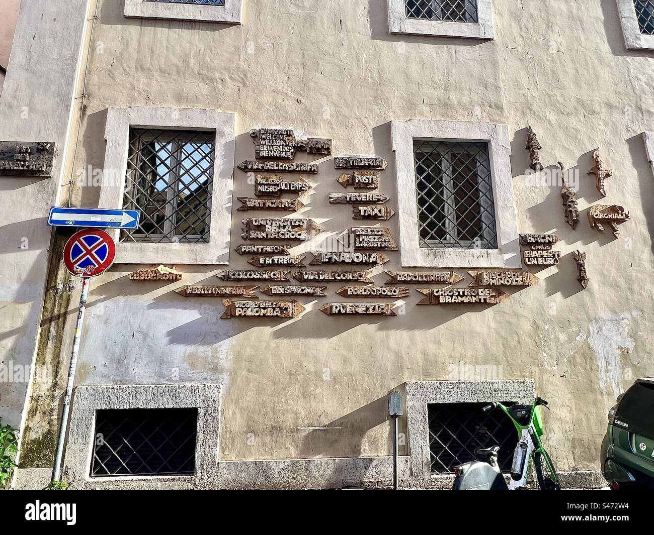Signs on a building on Via Dei Pianellari street point the direction of ...