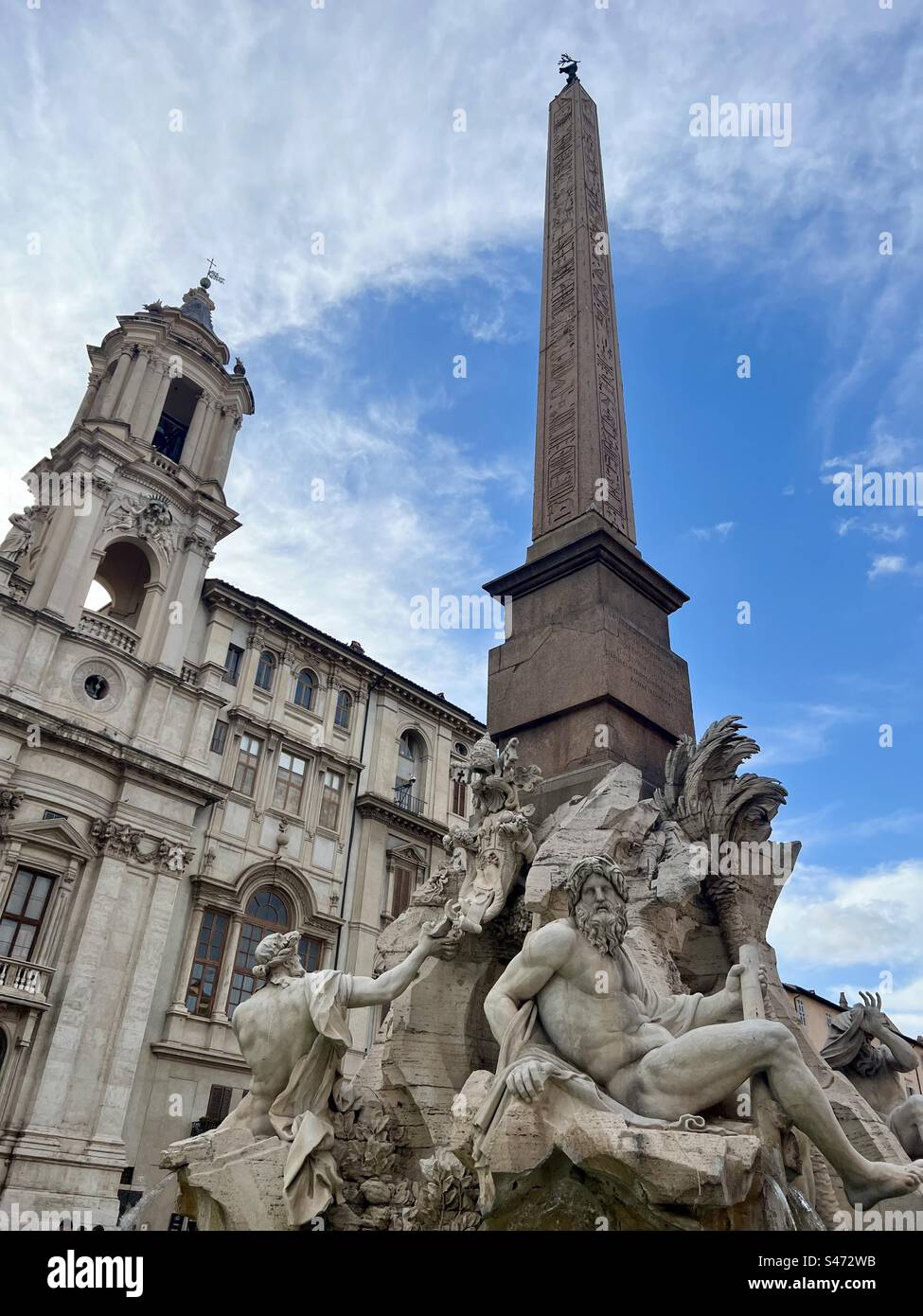 Sculpture, obelisk, and bell tower in Piazza Navona, Rome Stock Photo ...